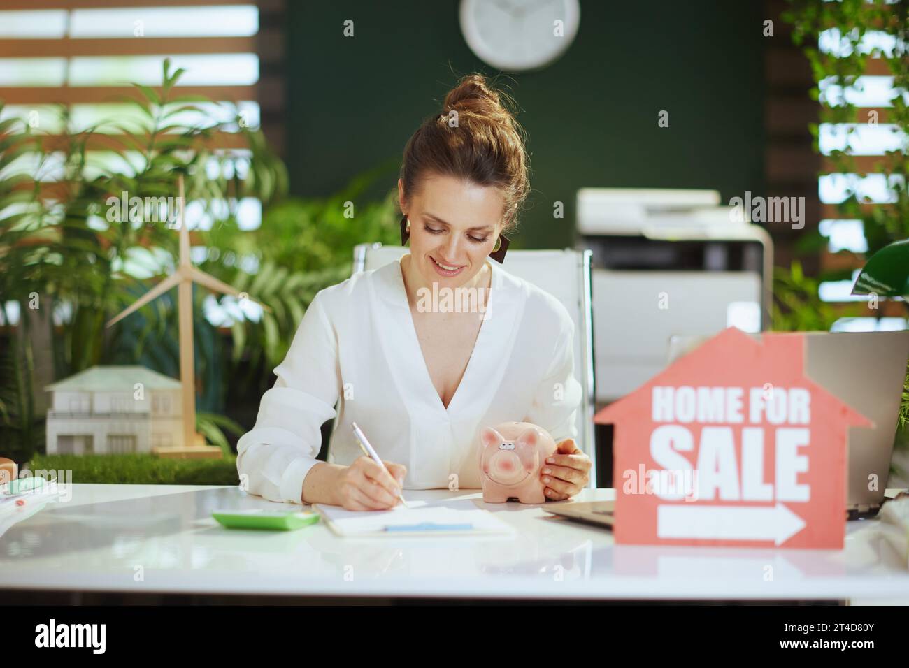 Sustainable real estate business. pensive elegant woman realtor in ...