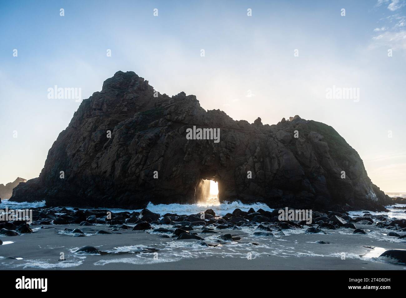 Wide-angle shot of the keyhole arch at Pfeiffer beach, California, whit ...