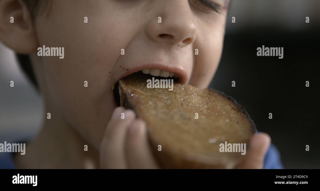 Speed-Ramp of Little Boy Biting Toast Bread Stock Photo - Alamy