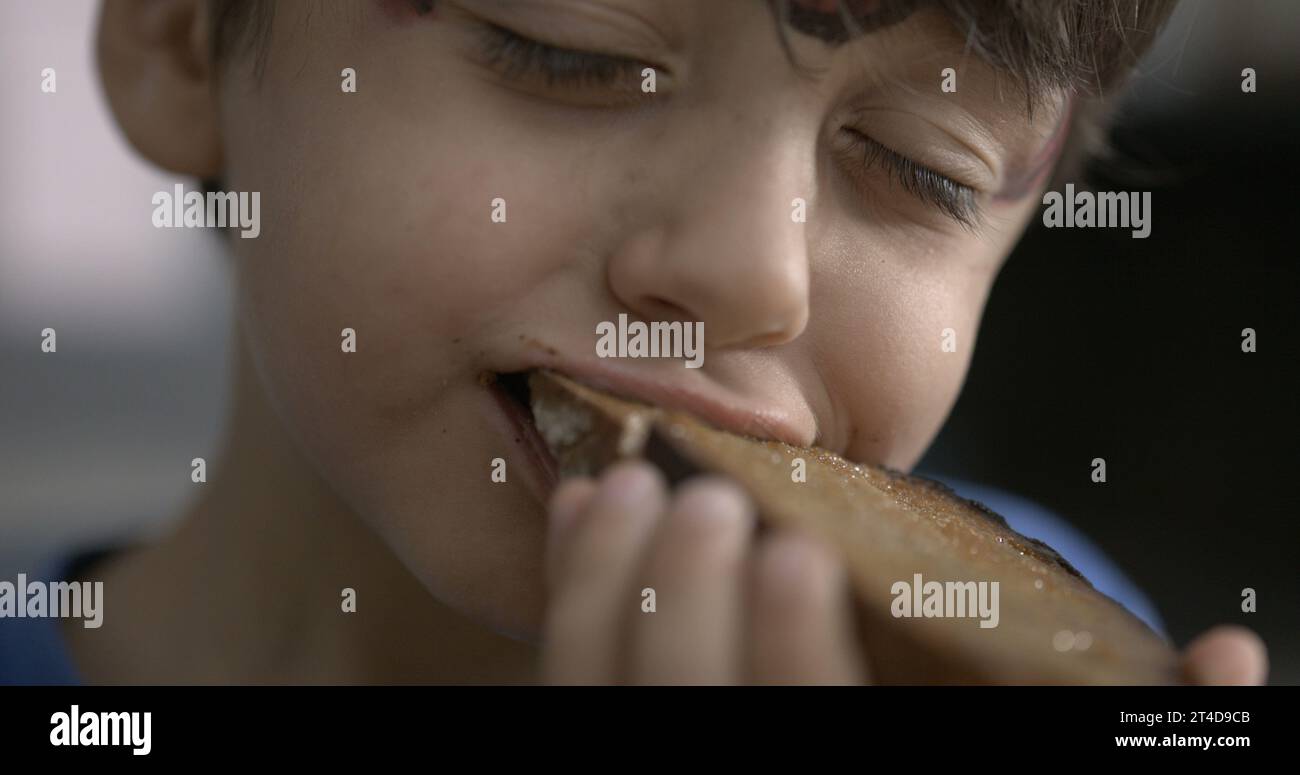 Speed-Ramp of Little Boy Biting Toast Bread Stock Photo - Alamy