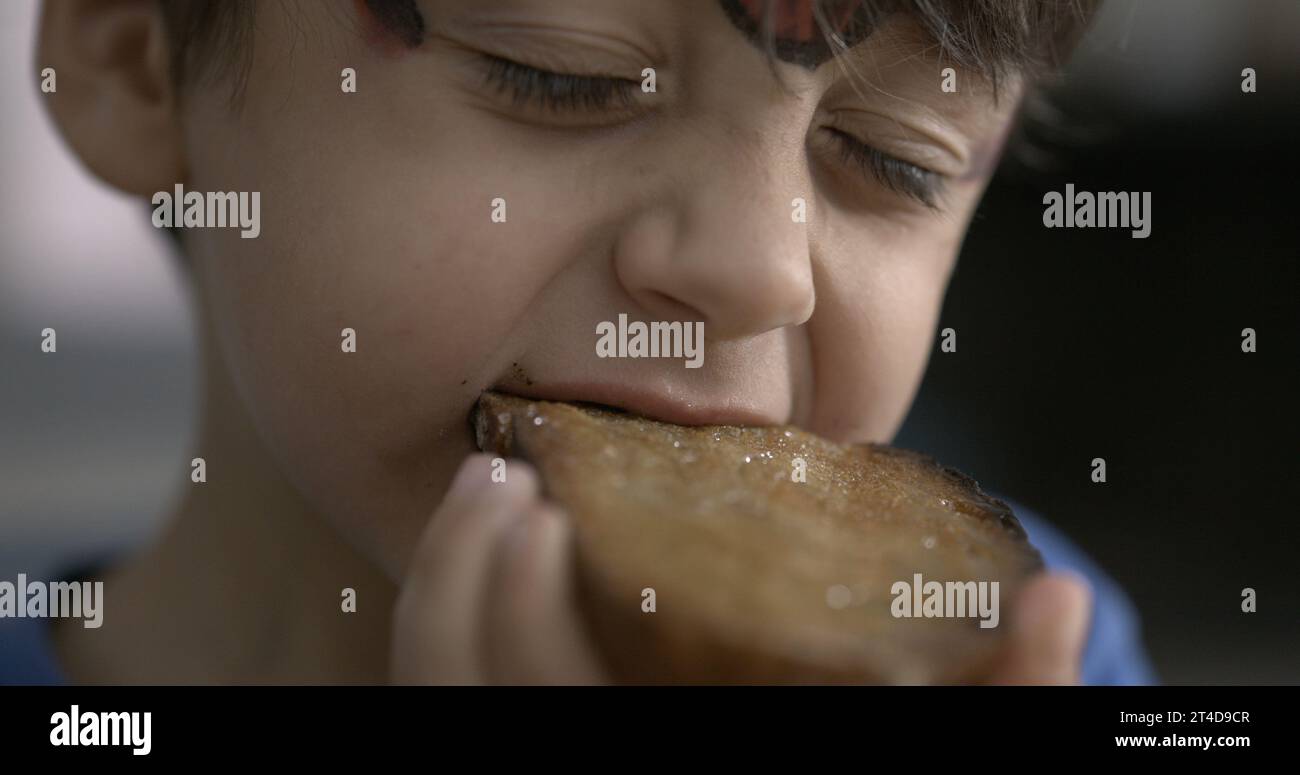 Speed-Ramp of Little Boy Biting Toast Bread Stock Photo - Alamy