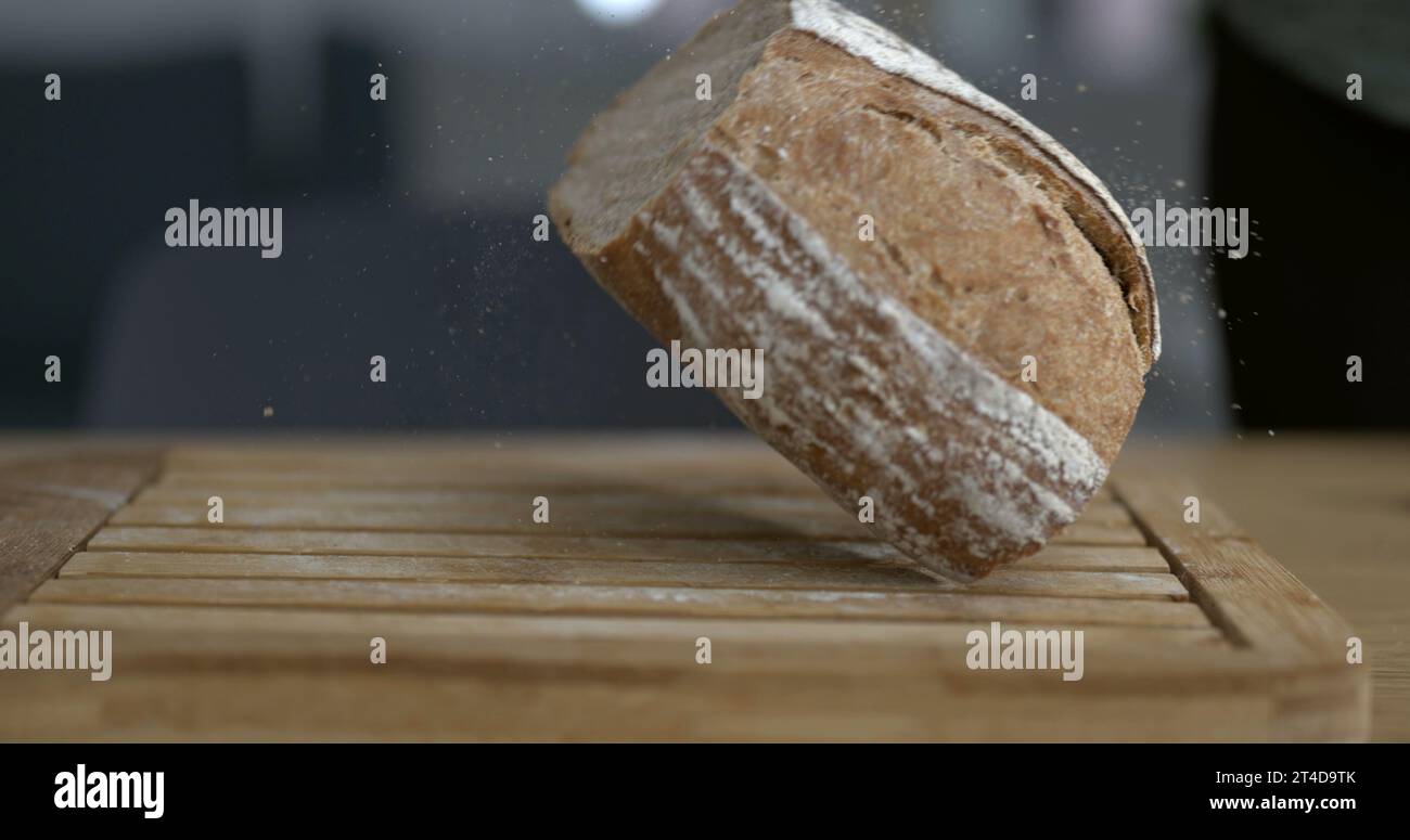 Falling traditional rustic bread captured with camera with flour and ...