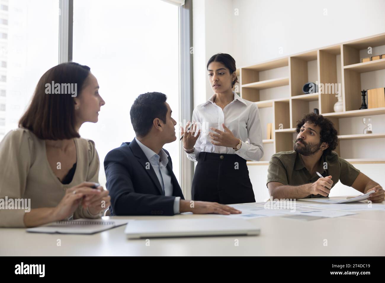 Serious young Indian professional woman coaching company staff Stock ...