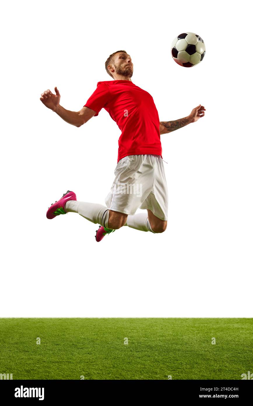 Young man, professional player in red sportwear and boots performing ...