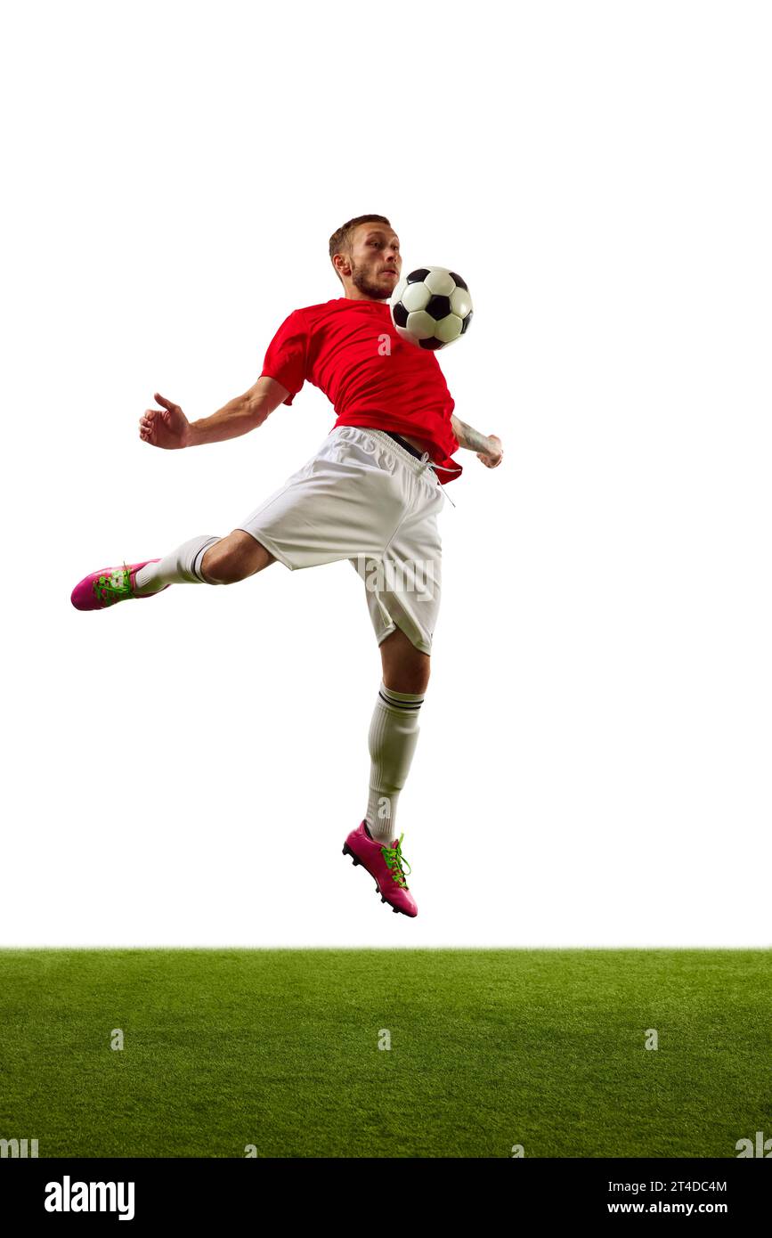 Young man, professional soccer player in red sportwear and boots ...