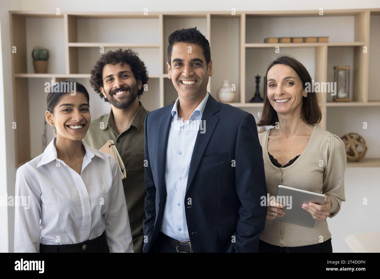 Happy professional colleagues and Indian team leader posing for ...