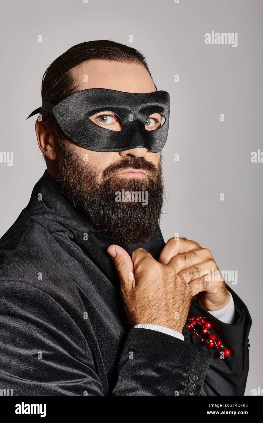 Christmas Masquerade, handsome bearded man in carnival mask and elegant ...
