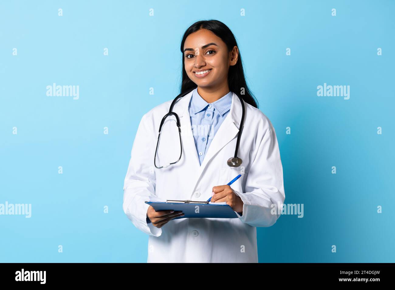 Professional Indian lady physician with stethoscope and medical chart ...