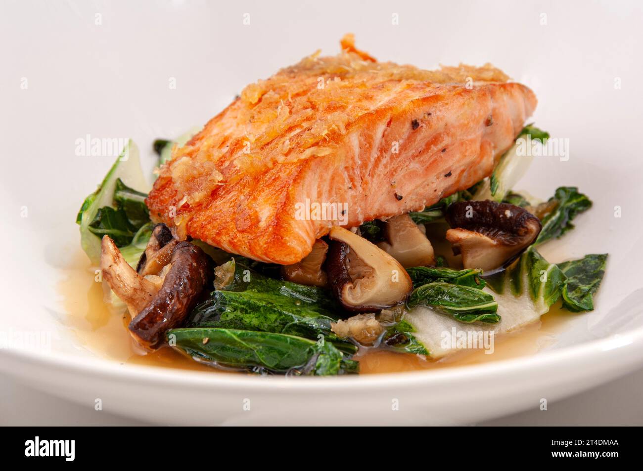 Cooked wild salmon on a bed of mushrooms and cabbage Stock Photo - Alamy