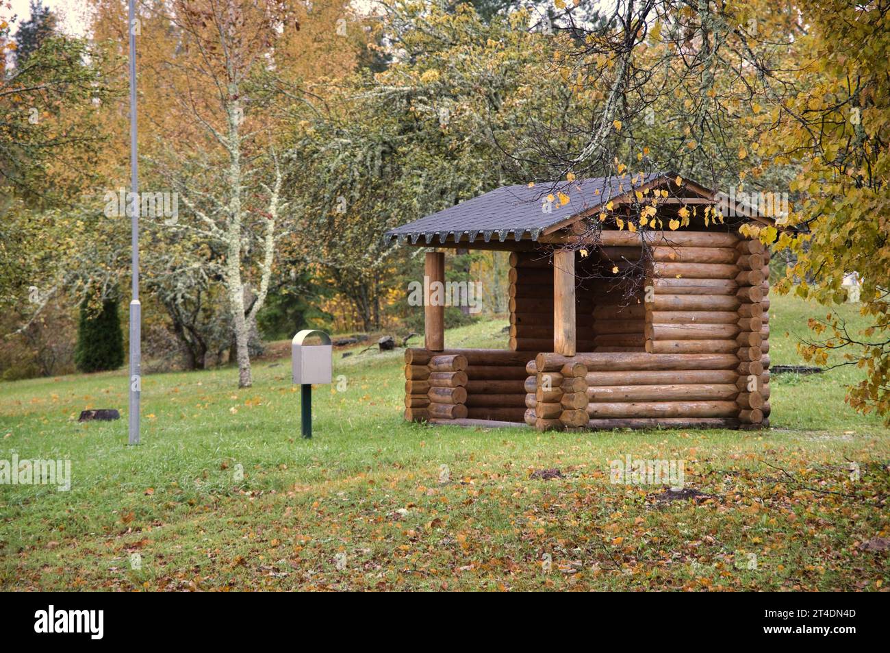 Wooden log cabin bus stop. An opportunity to hide from bad weather ...