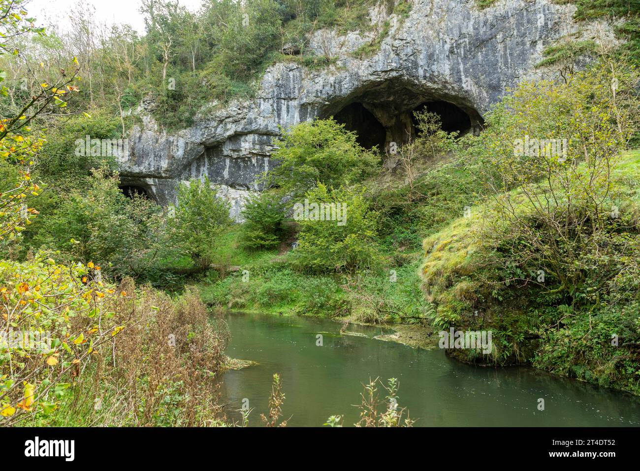 The River Dove with Dove Holes caves in Dovedale valley, Peak District ...