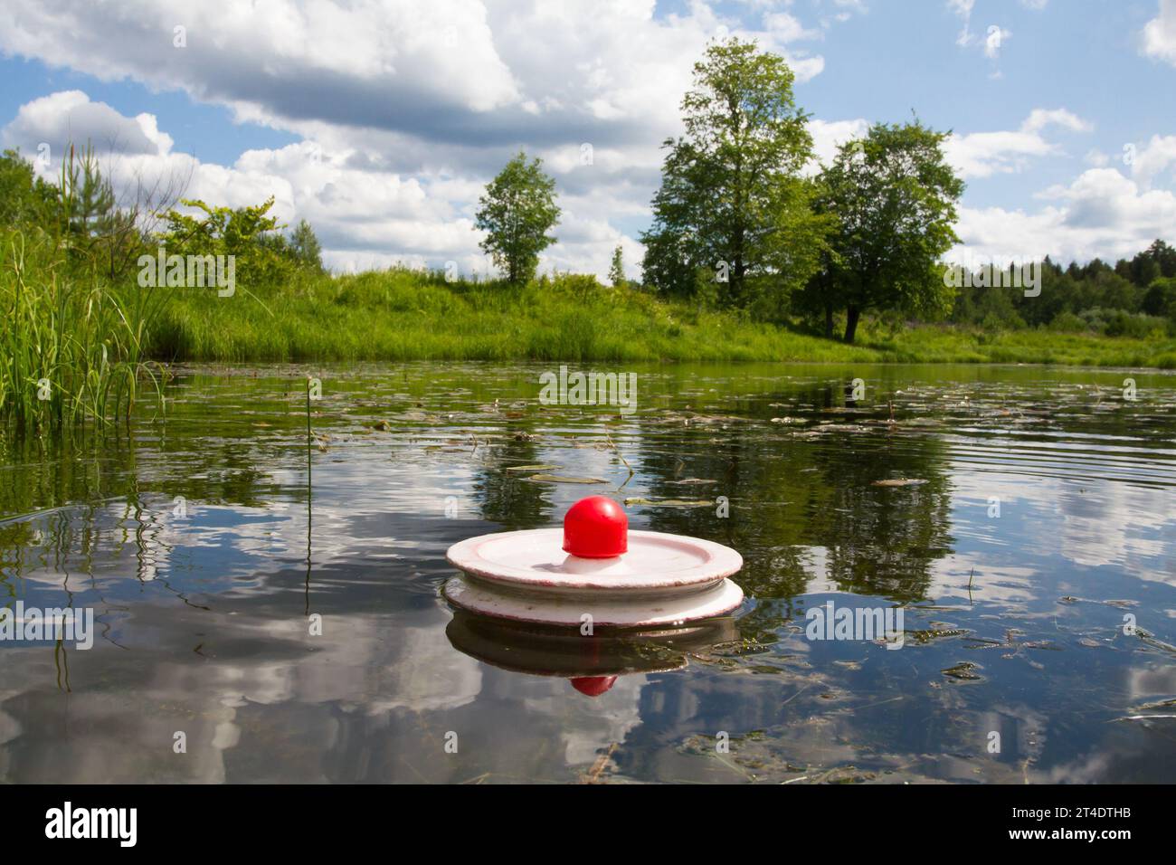 fishing trap (circle) signals bite of predatory fish on the surface of ...