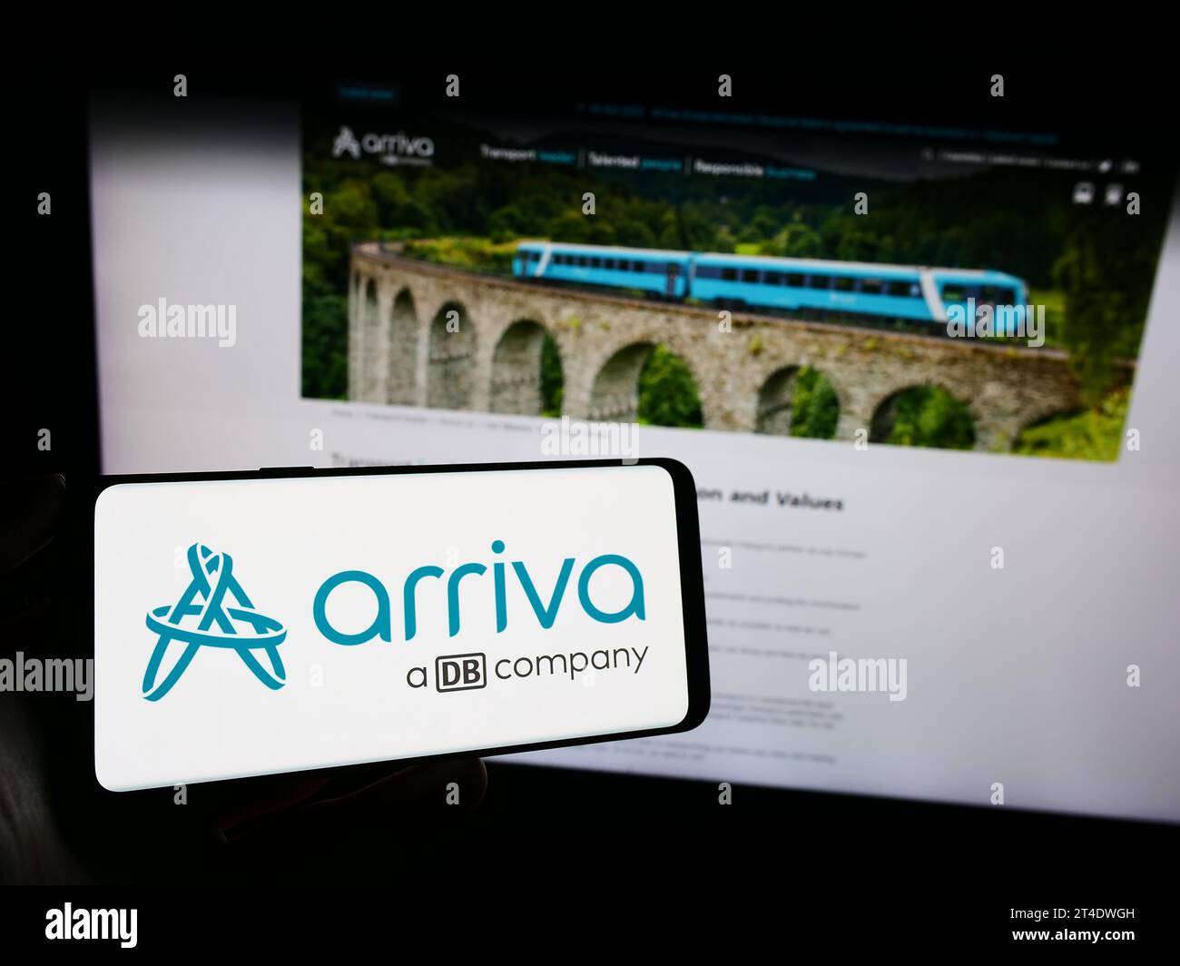 Person holding cellphone with logo of British public transport company ...