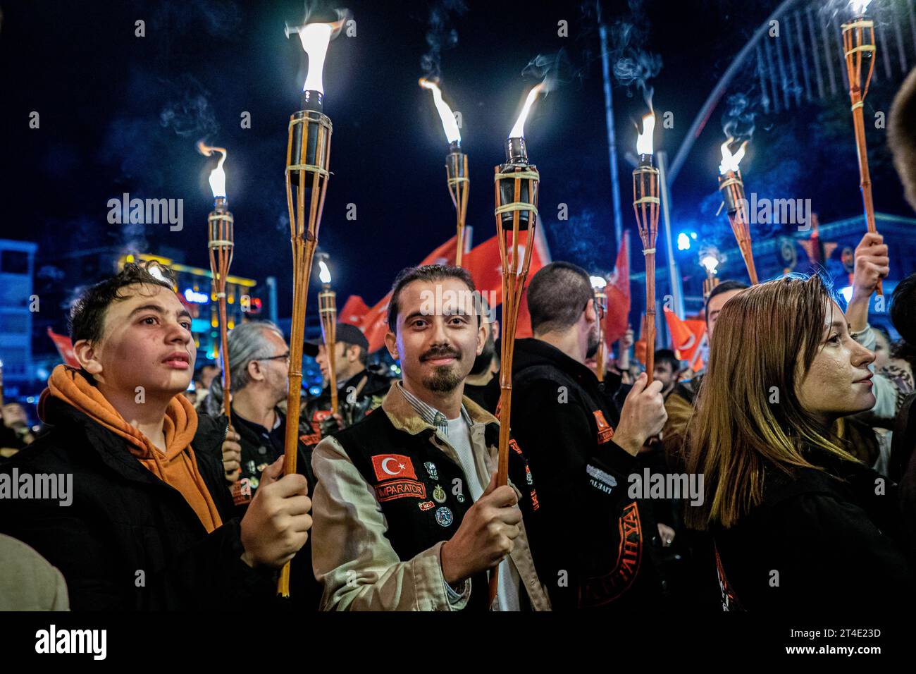 A group of people join the torchlight procession with torches in their ...