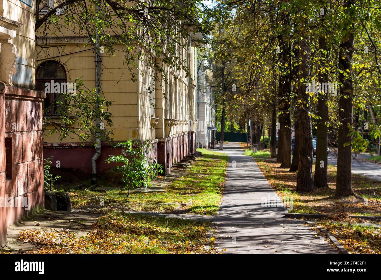 Pedestrian sidewalk near the walls of residential buildings in a ...