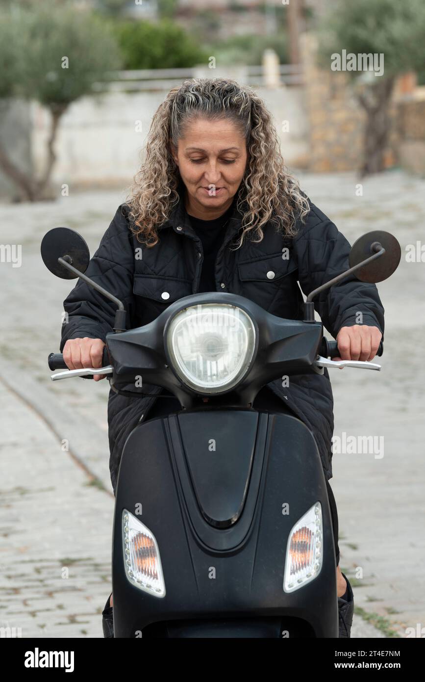 Female motor scooter rider hi-res stock photography and images - Alamy