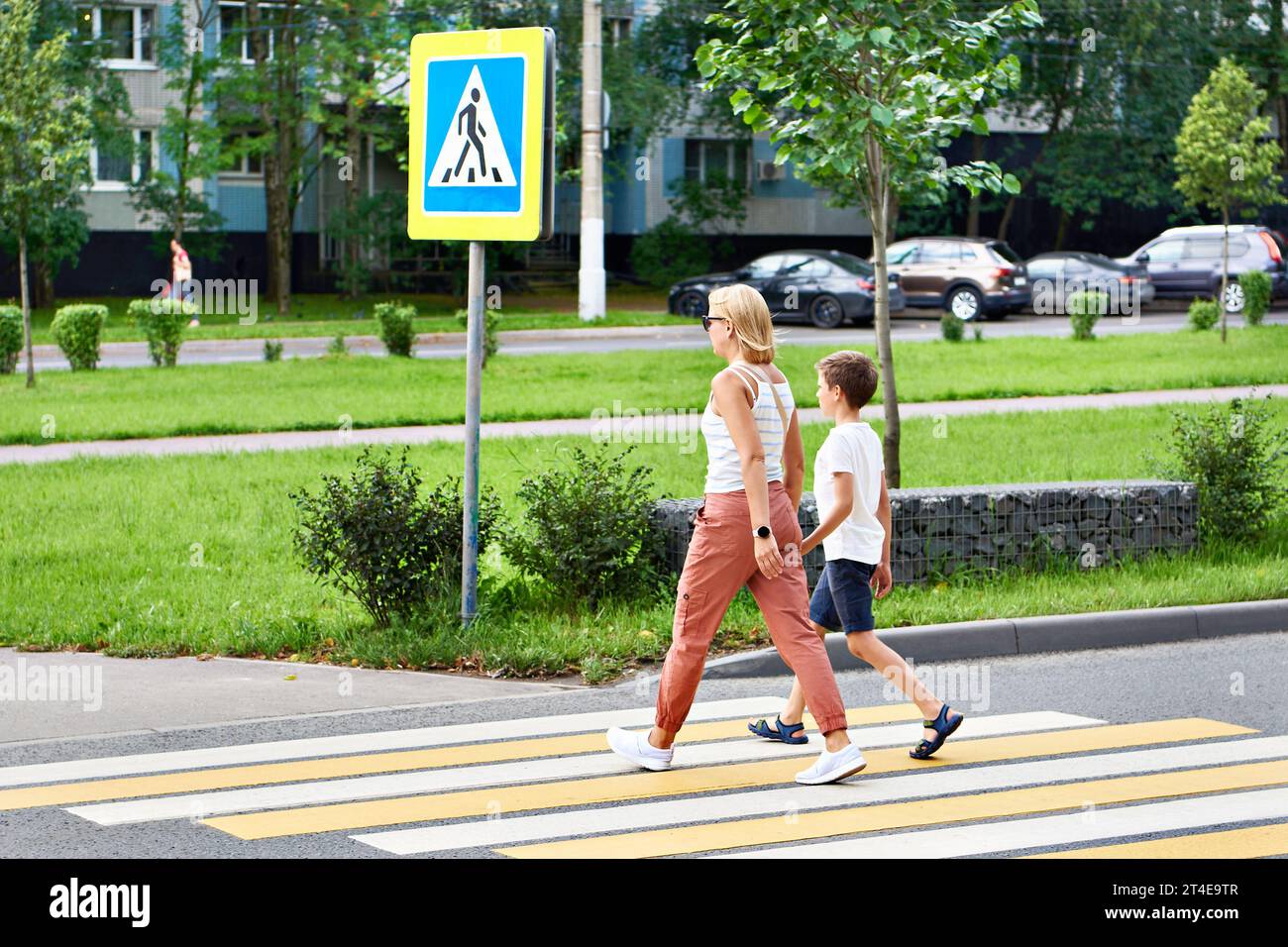 Mother and child walk on pedestrian crossing Stock Photo - Alamy