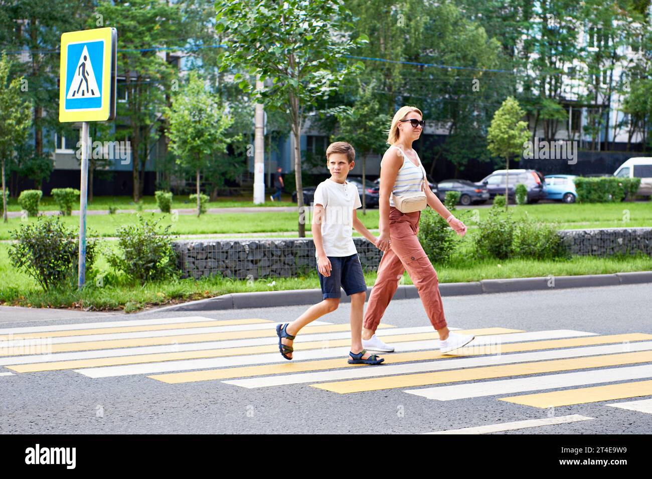 Mother and child walk on pedestrian crossing Stock Photo - Alamy