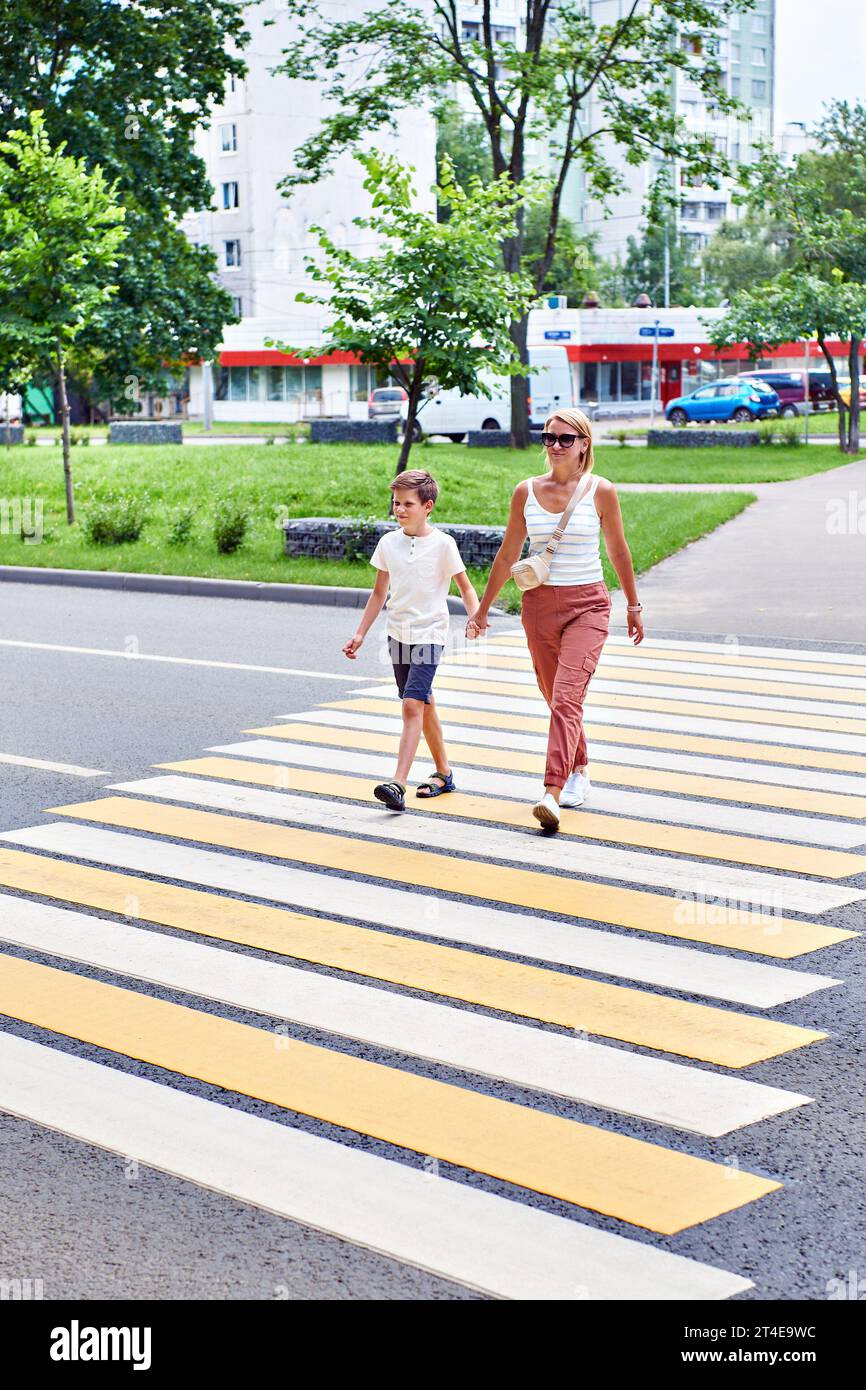 Mother and child walk on pedestrian crossing Stock Photo - Alamy