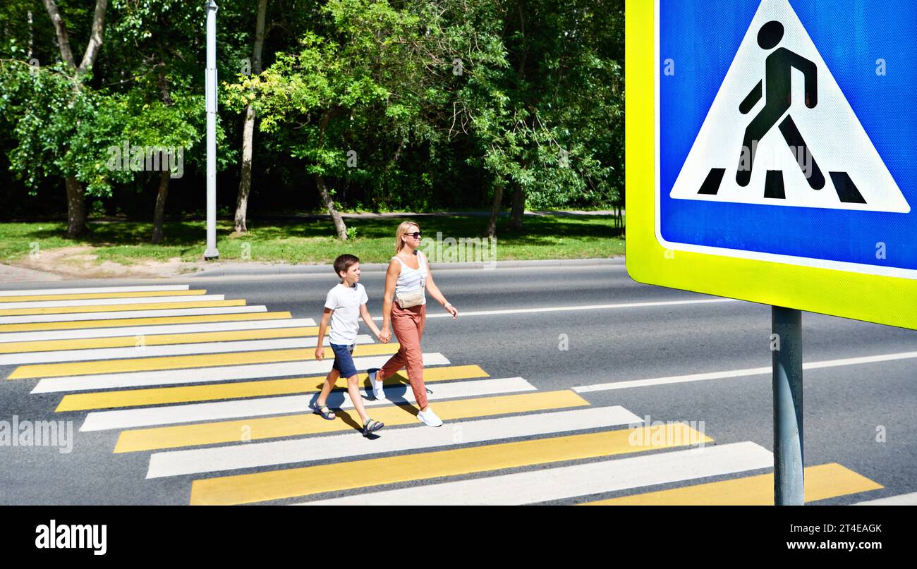 Mother and child walk on pedestrian crossing Stock Photo - Alamy
