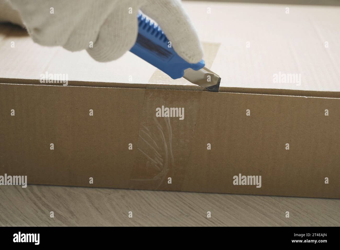 Cutting open a box hi-res stock photography and images - Alamy