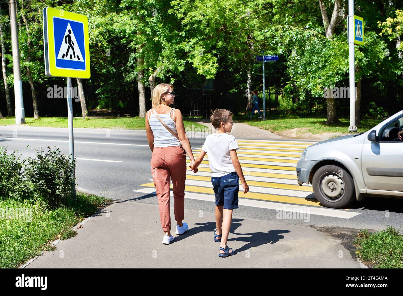 Mother and child walk on pedestrian crossing Stock Photo - Alamy
