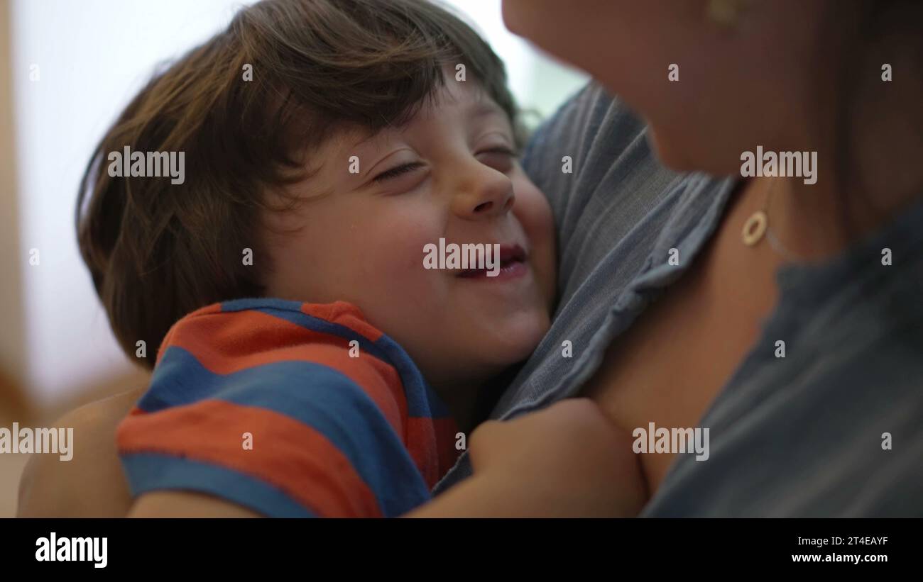 Affectionate mother holding child in arms, authentic loving tender ...