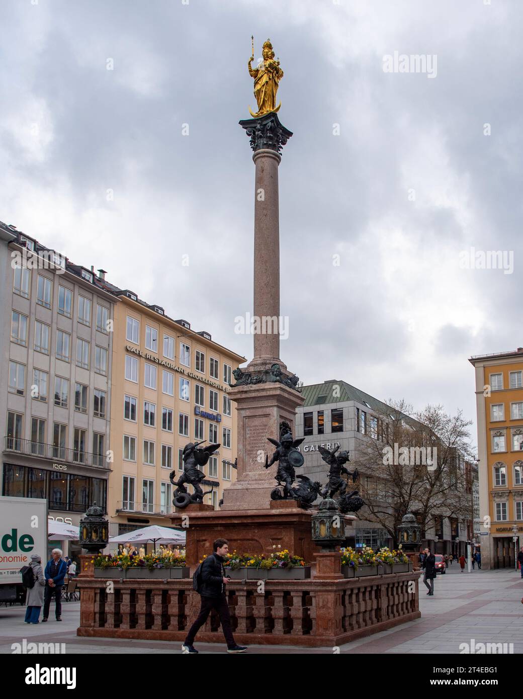 Golden statue of Mary on top of Mariensaule located on the Marienplatz ...