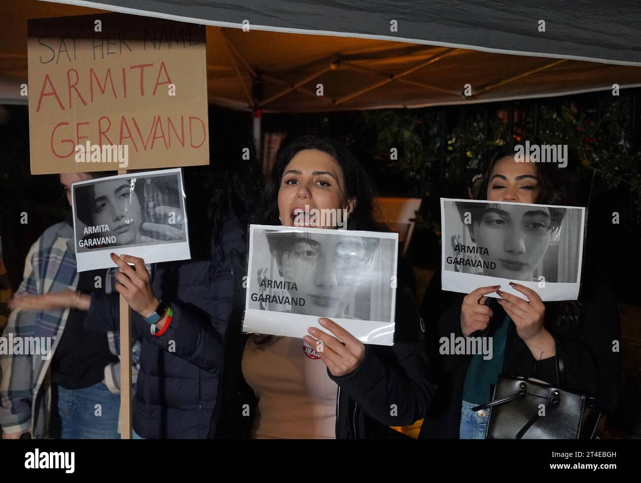 Protesters hold pictures of Armita Geravand as they take part in a ...