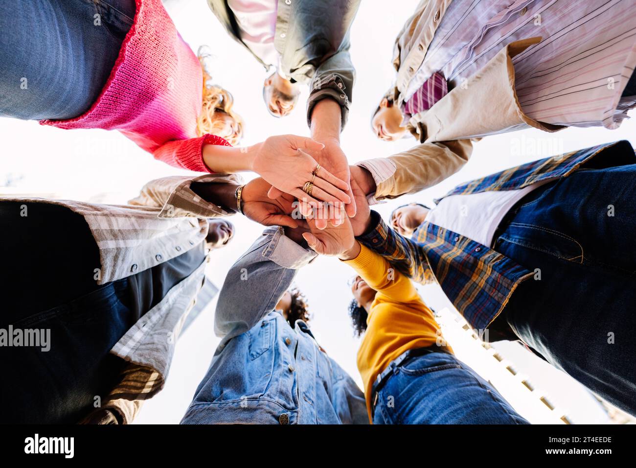 United young group of diverse people joining hands outdoors Stock Photo - Alamy