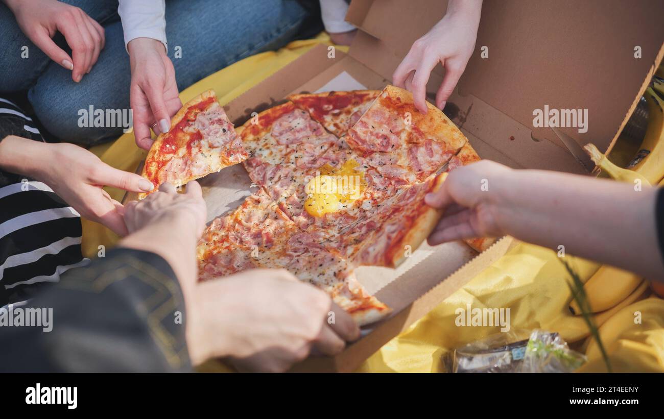 Hands reaching for pizza hi-res stock photography and images - Alamy