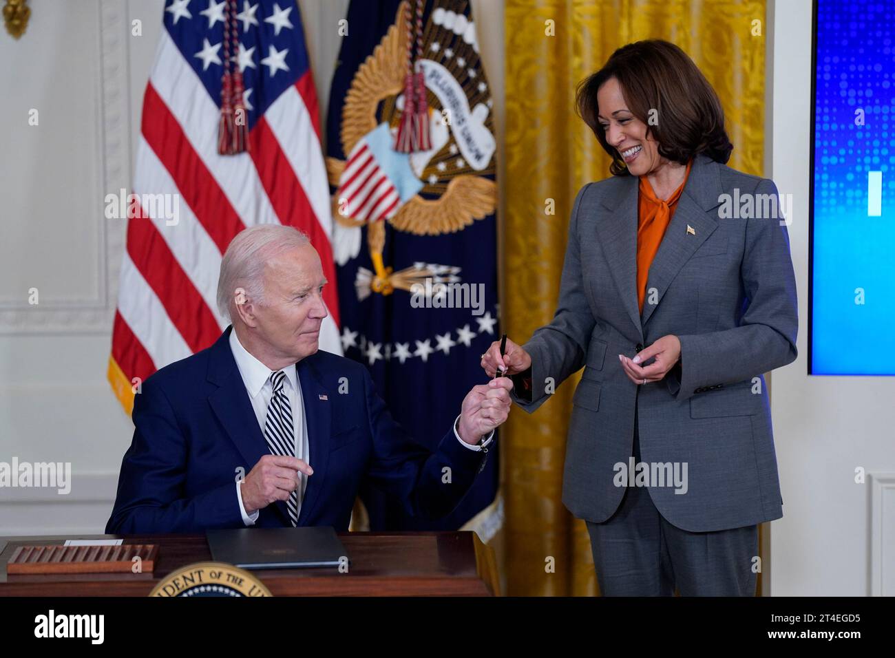President Joe Biden hands the pen he used to sign an executive on ...
