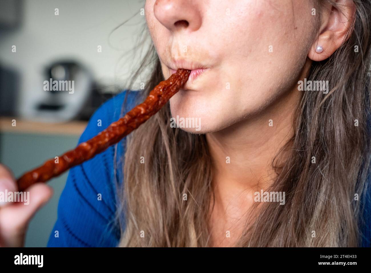 Woman eats food. Woman eats Kabanos dry sausage. Close shot of girl ...