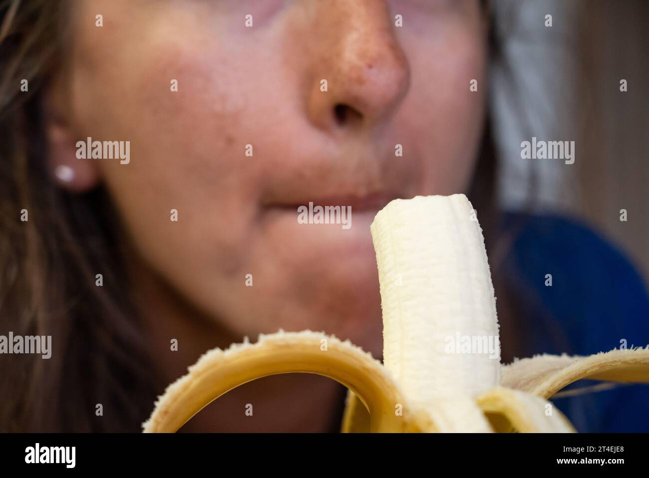 Woman eats food. Woman eats banana. Close shot of girl eating bananas ...