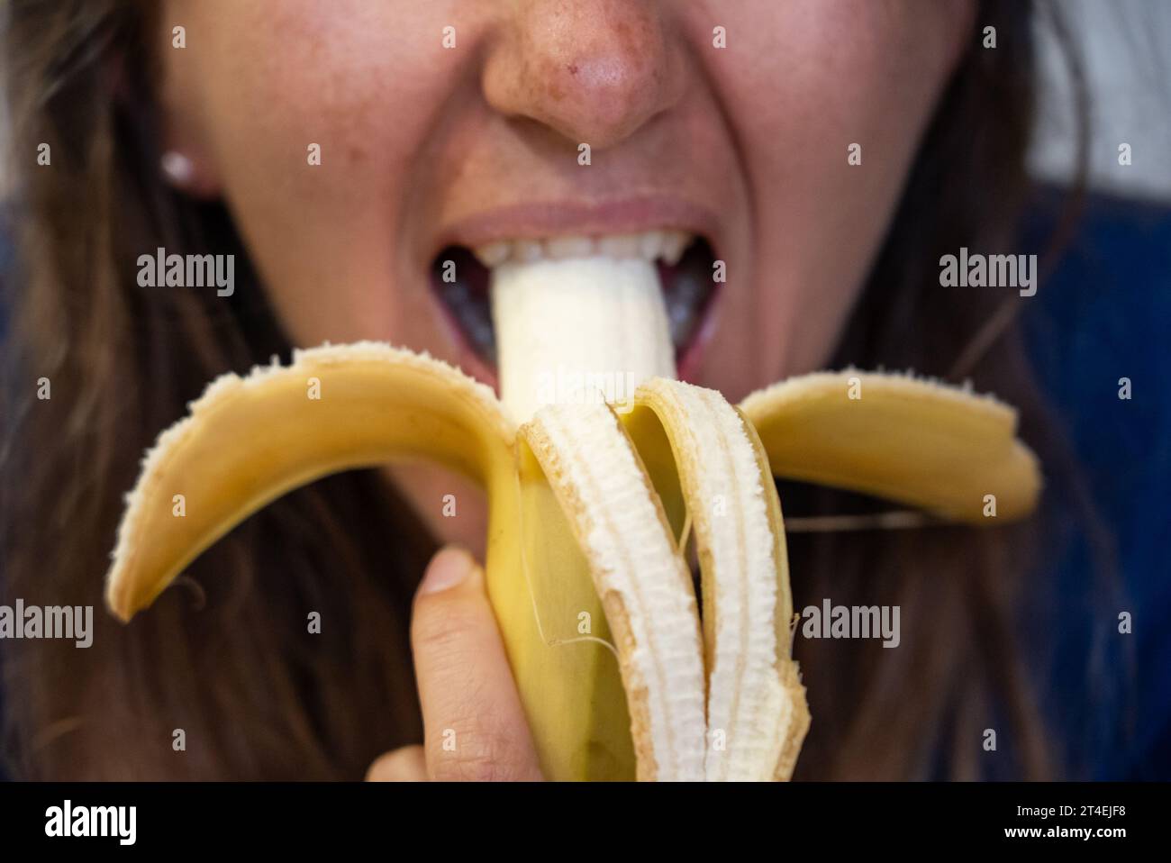 Woman eats food. Woman eats banana. Close shot of girl eating bananas ...