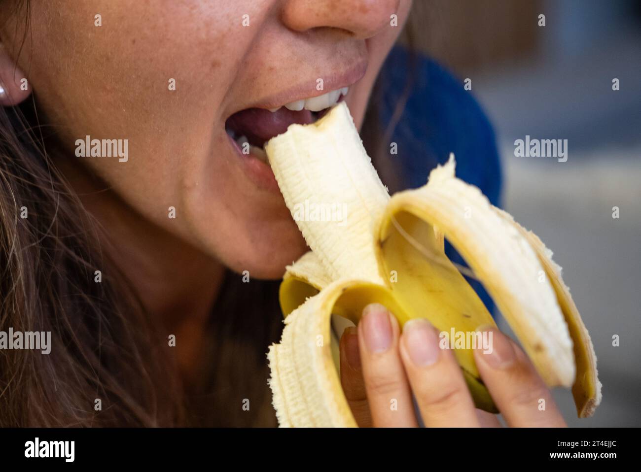 Woman eats food. Woman eats banana. Close shot of girl eating bananas ...