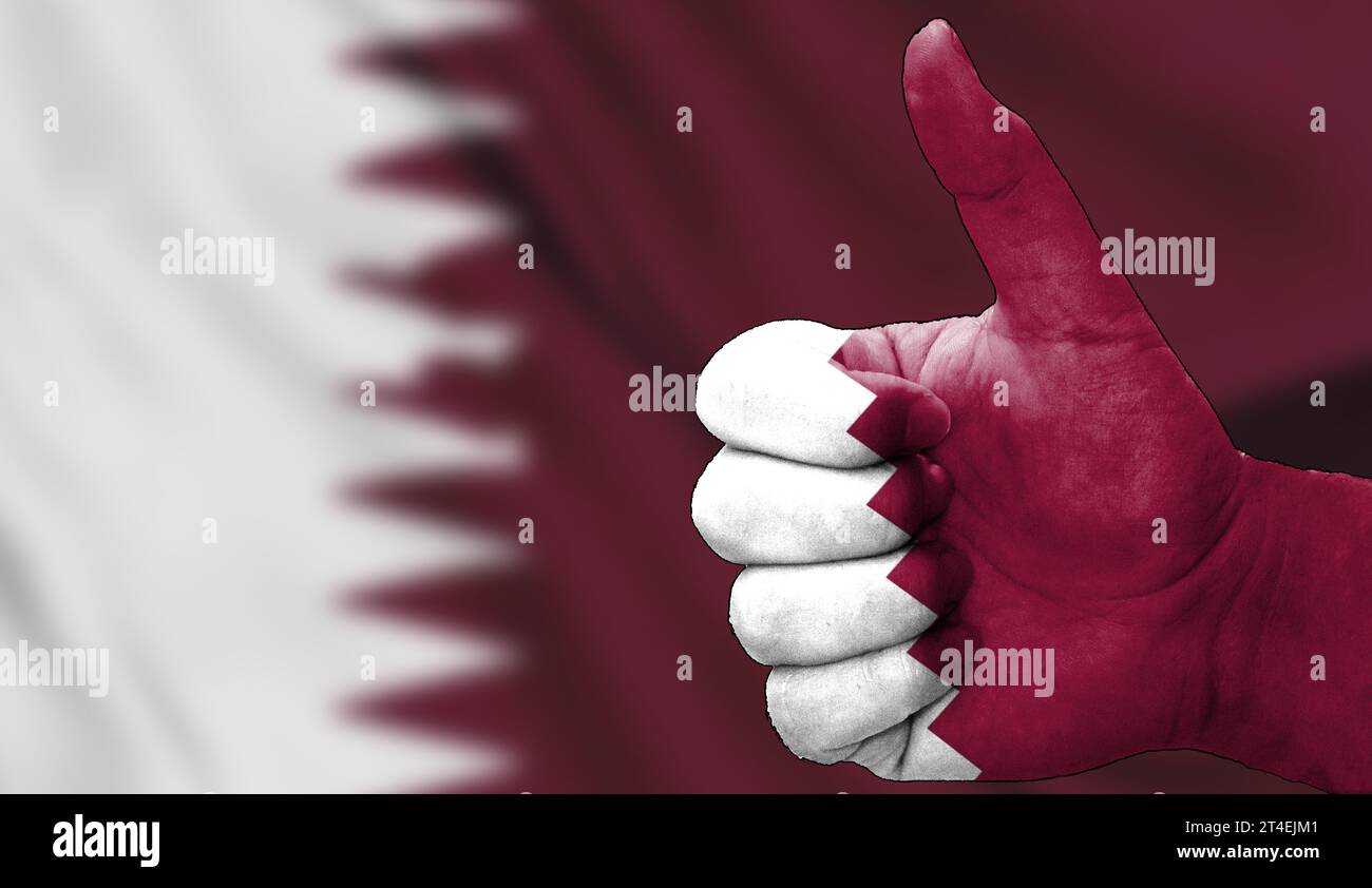 hand with thumbs up in approval with the Qatari flag painted. Image ...