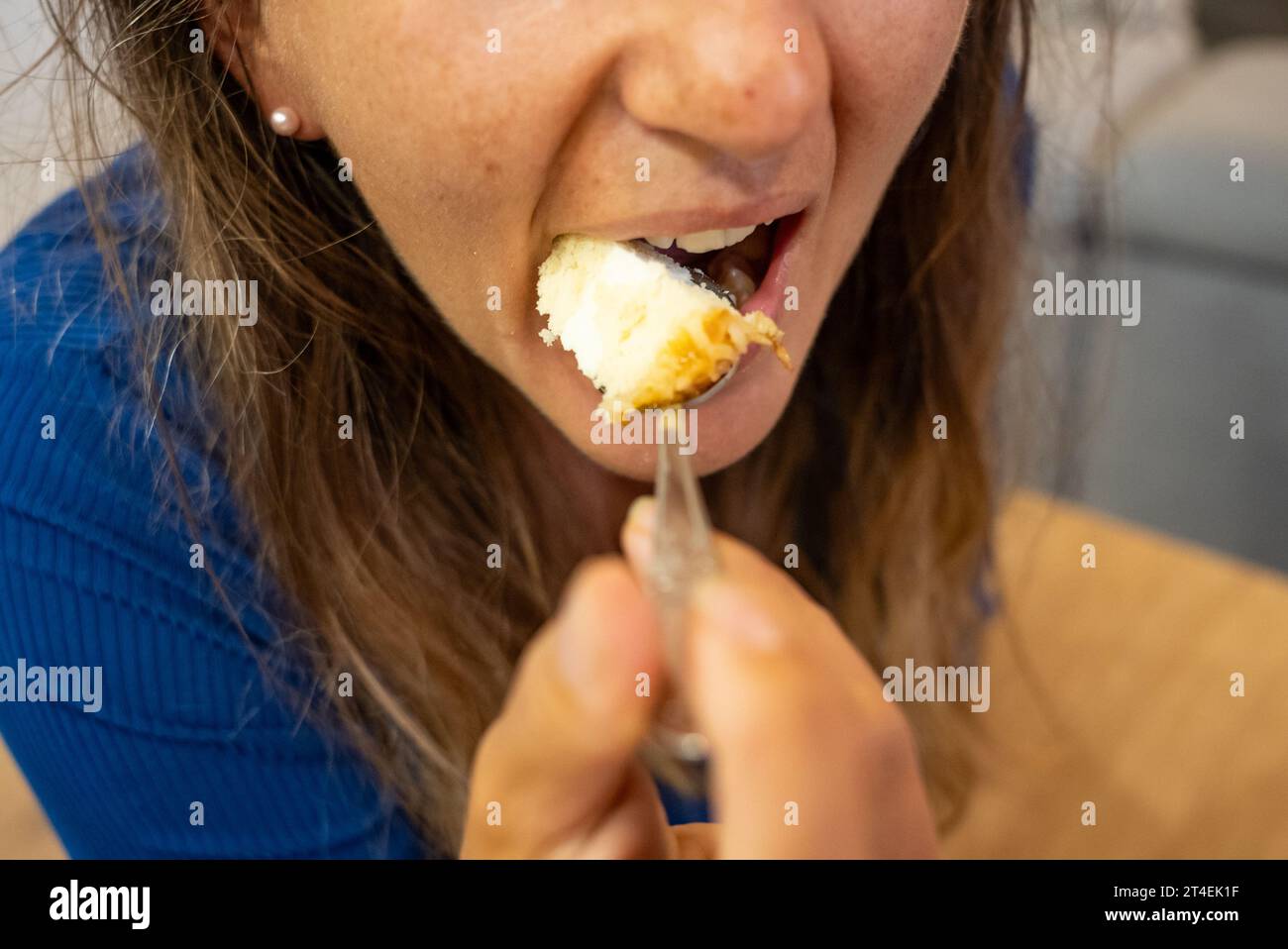 Woman eats food. Woman eats cheesecake. Close shot of girl eating cake ...