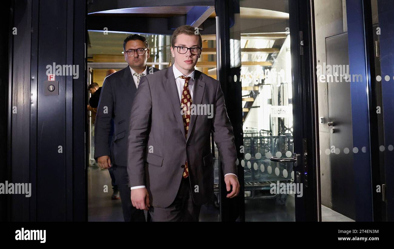 30 October 2023, Bavaria, Würzburg: AfD politician Daniel Halemba (v) leaves the courthouse at ...