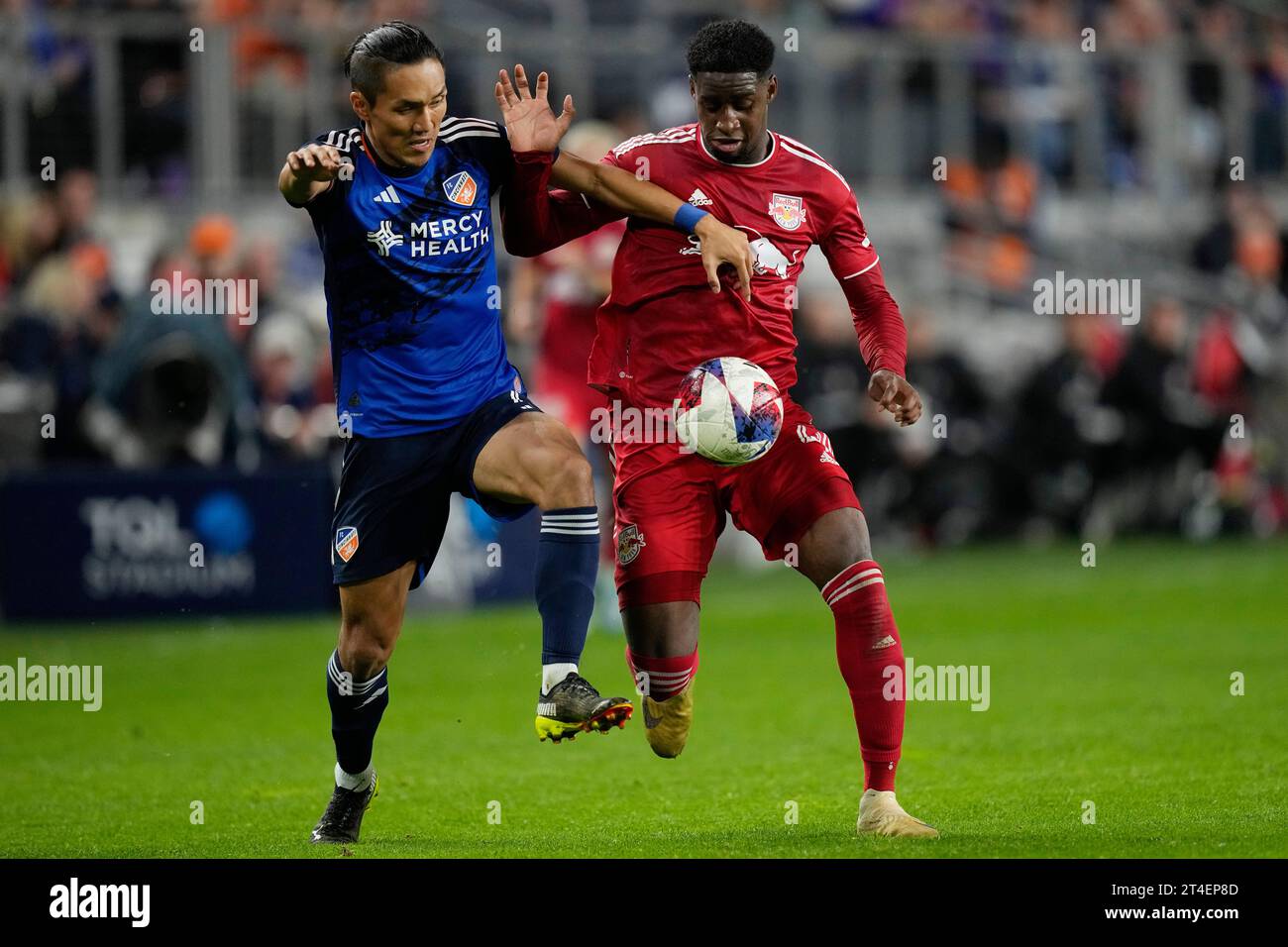 FC Cincinnati forward Yuya Kubo, left, and New York Red Bulls defender ...