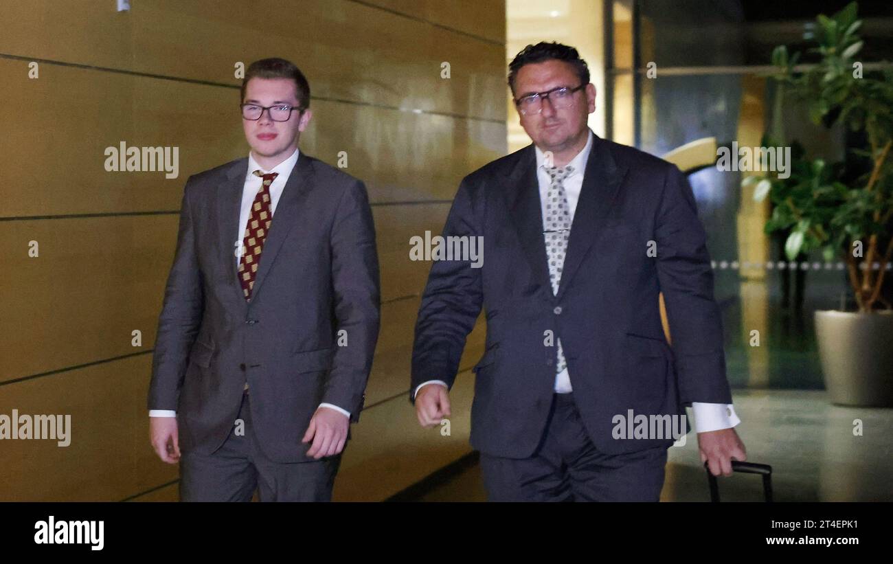 30 October 2023, Bavaria, Würzburg: AfD politician Daniel Halemba (l) leaves the courtroom at ...