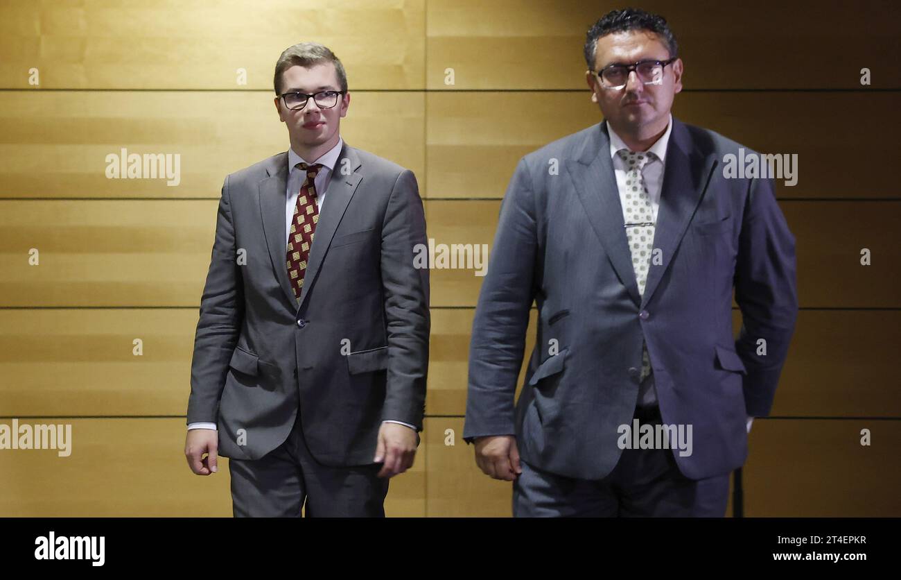 30 October 2023, Bavaria, Würzburg: AfD politician Daniel Halemba (l) leaves the courtroom at ...