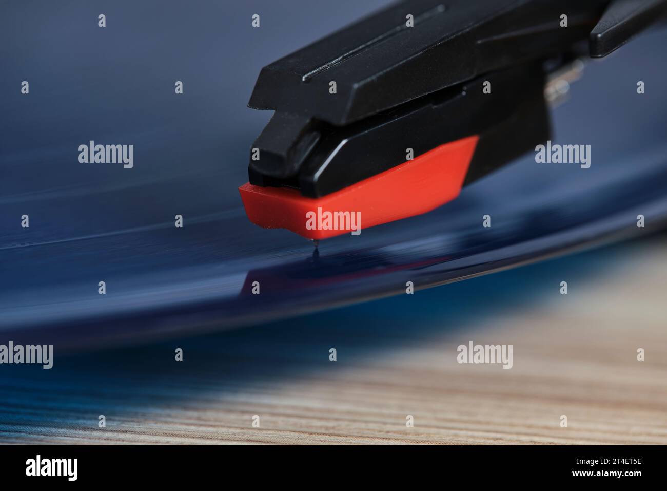 Needle of vinyl player is mounted on record. Closeup on macro photos ...