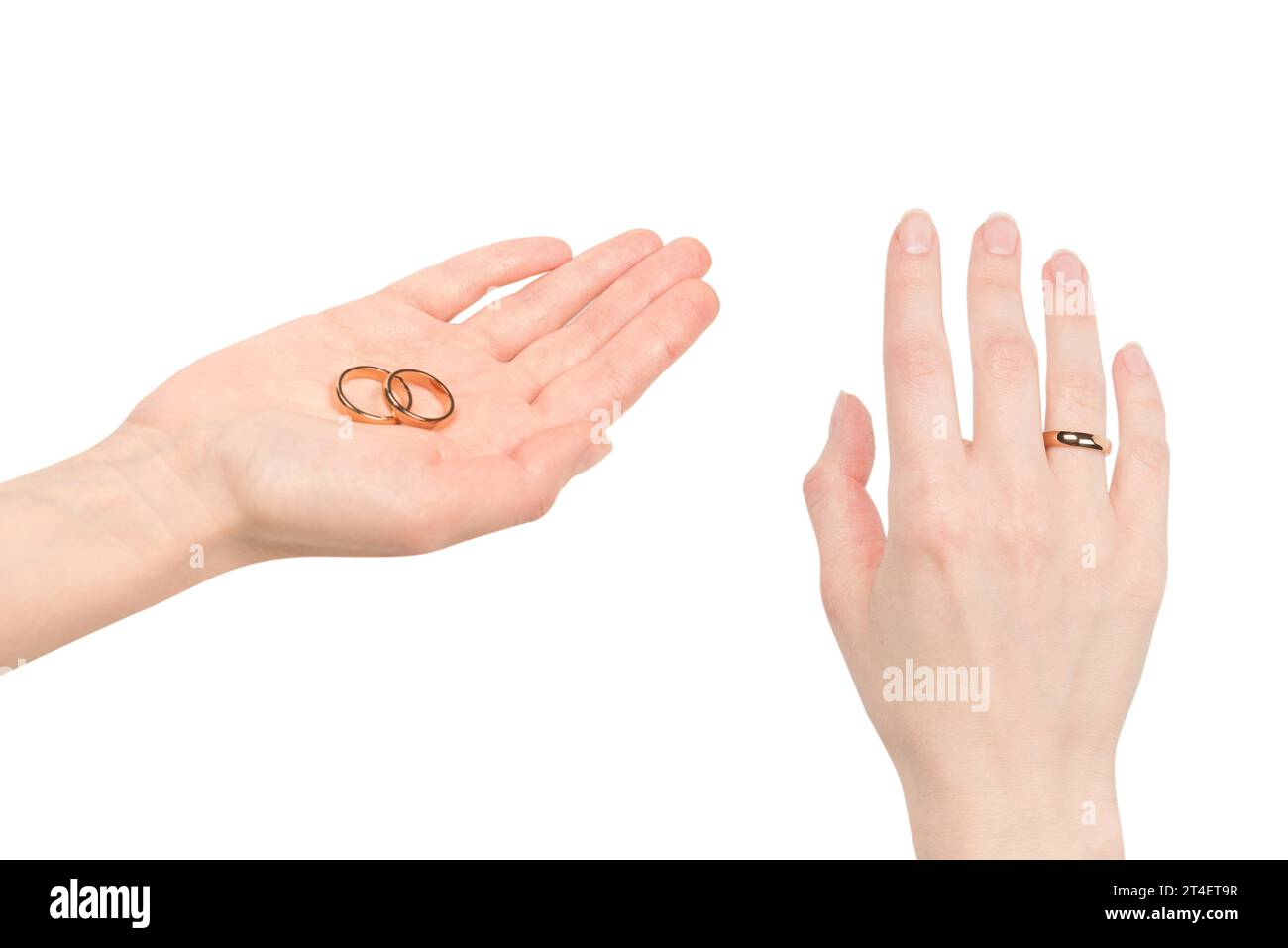 Two golden rings in a woman hand isolated on a white background ...