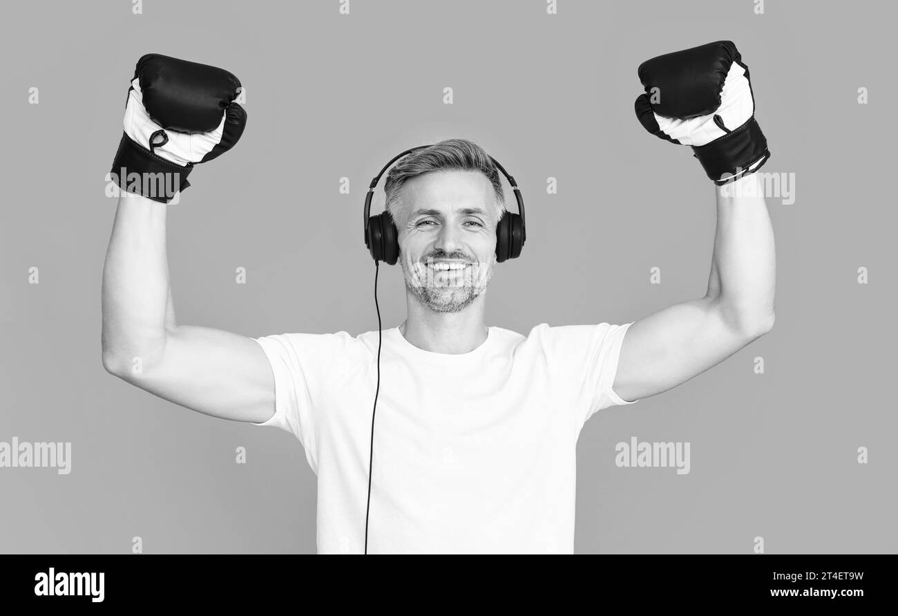 happy man boxer in sport boxing gloves at studio. man boxer in sport ...