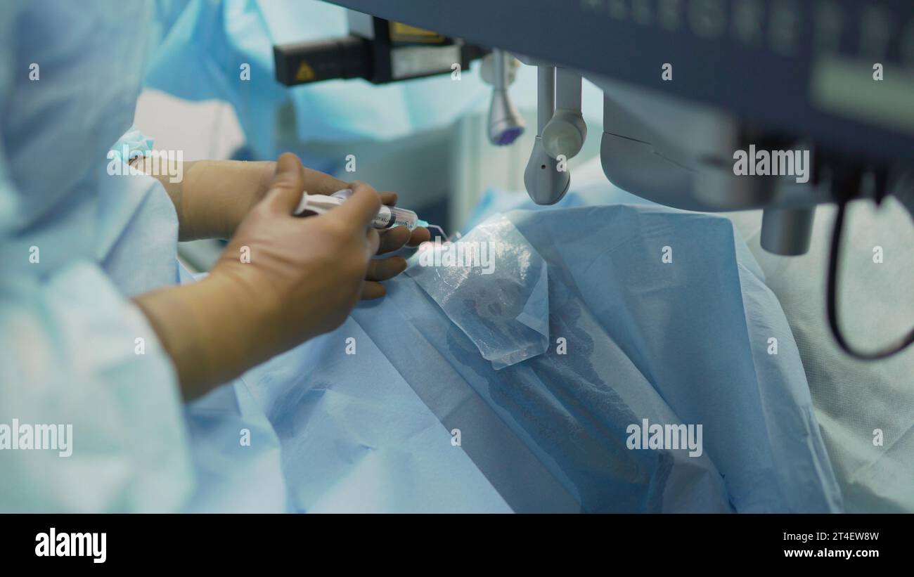 The doctor uses a syringe to instill the pain reliever into the patient ...