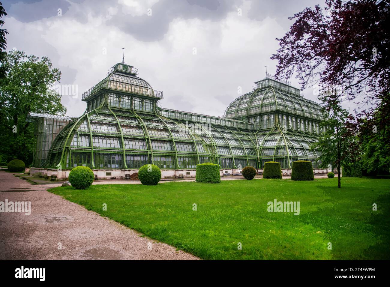 Botanical garden in Vienna:with green house and clody sky. Green grass ...