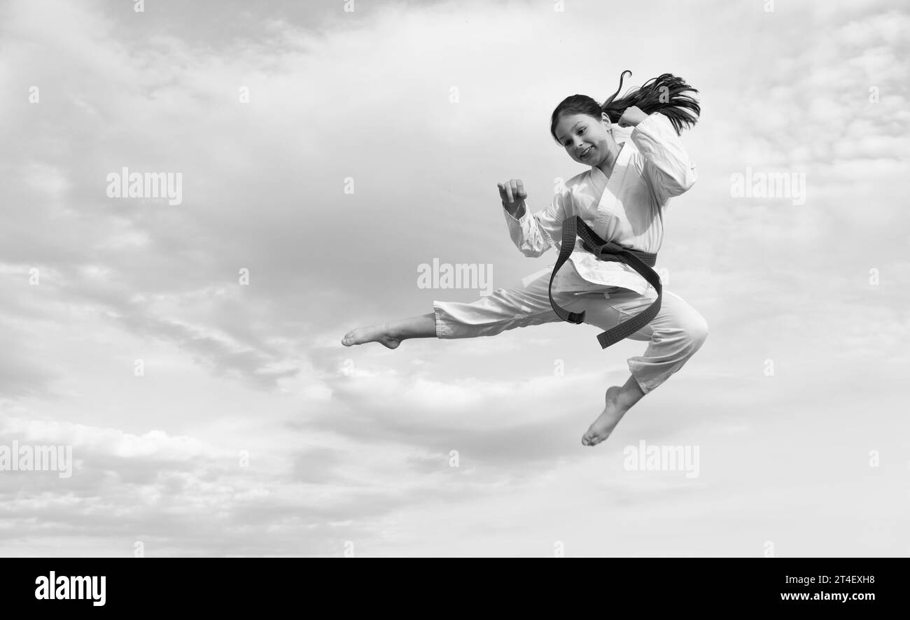 martial art concept. teen girl practicing martial art. girl martial fighter jump on sky ...