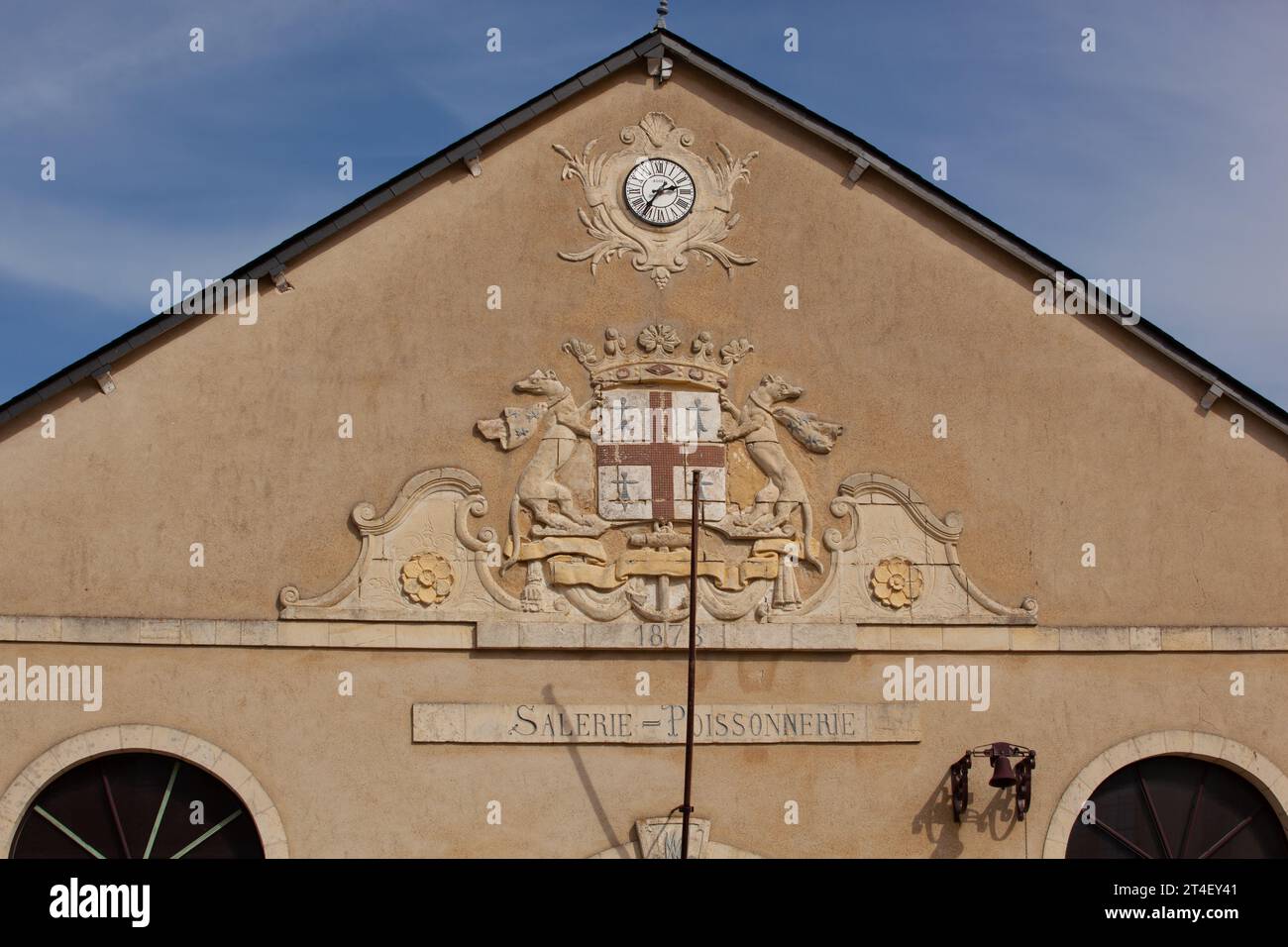 Facade with clock, coat of arms and inscription Stock Photo - Alamy