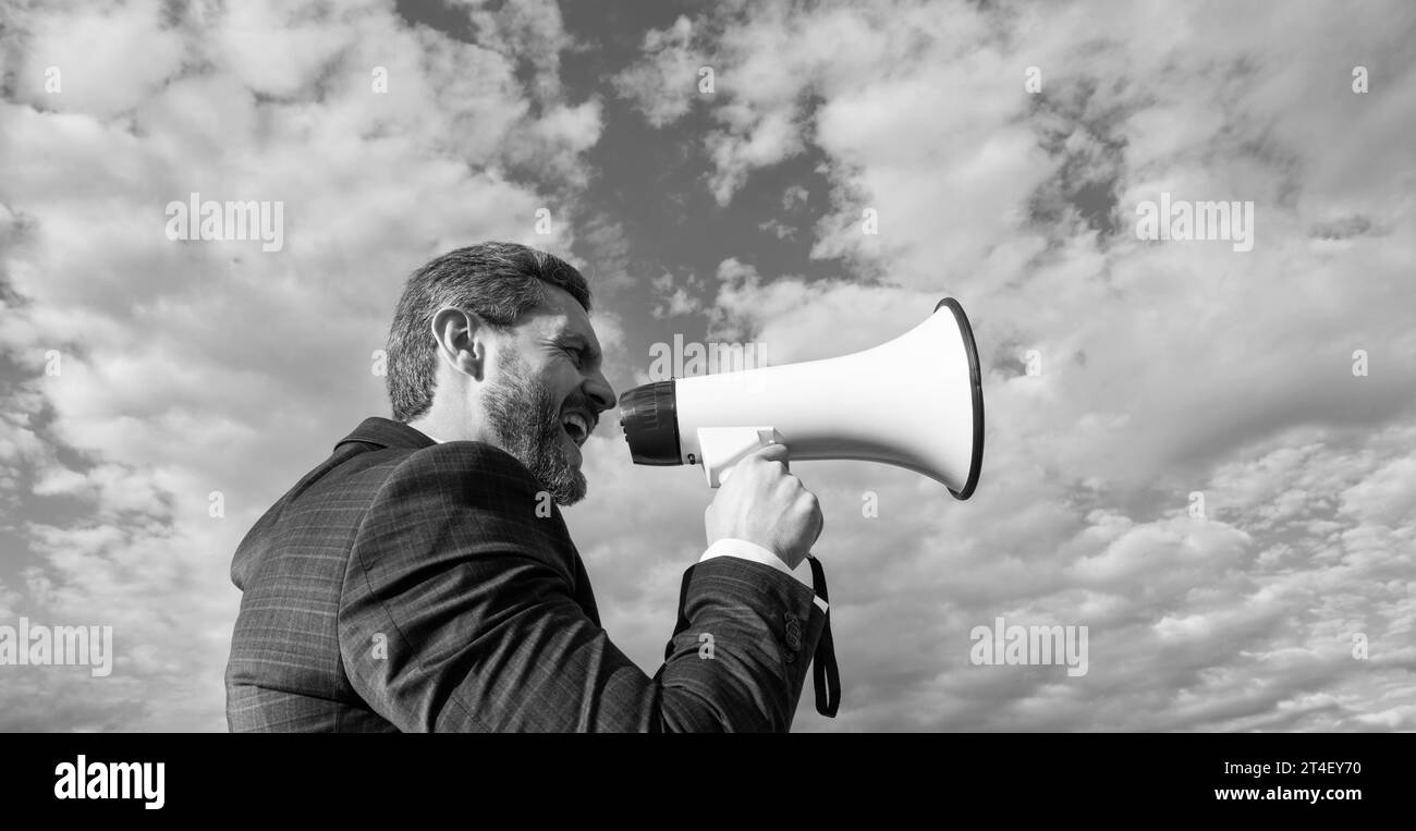 businessman shout in loud hailer on sky background Stock Photo - Alamy